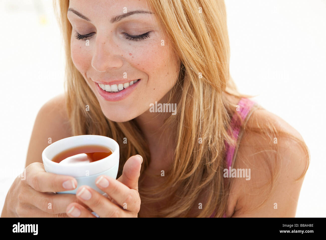 young woman enjoying cup of tea Stock Photo - Alamy