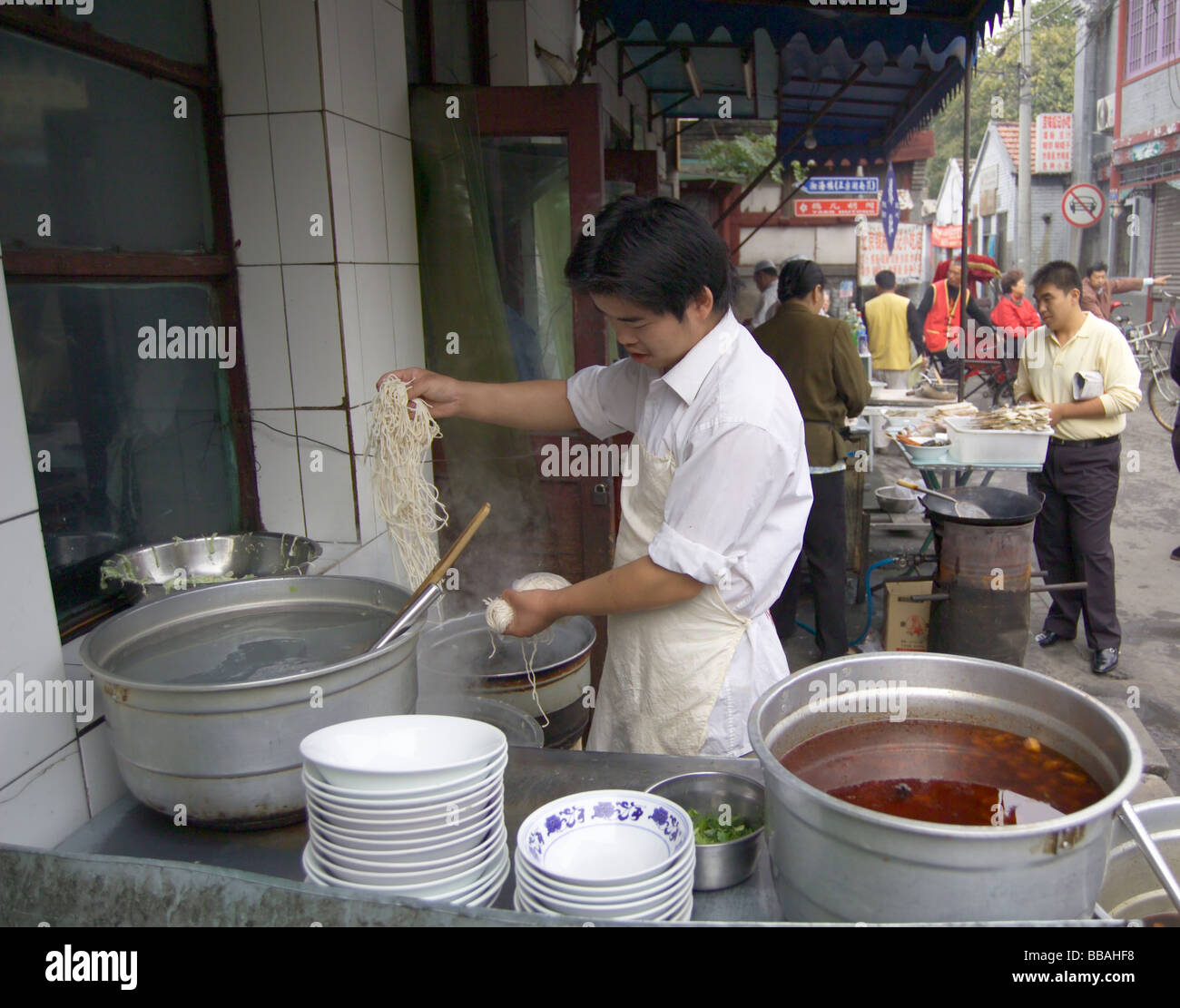 cooking on the street corner in Beijing, China Stock Photo - Alamy