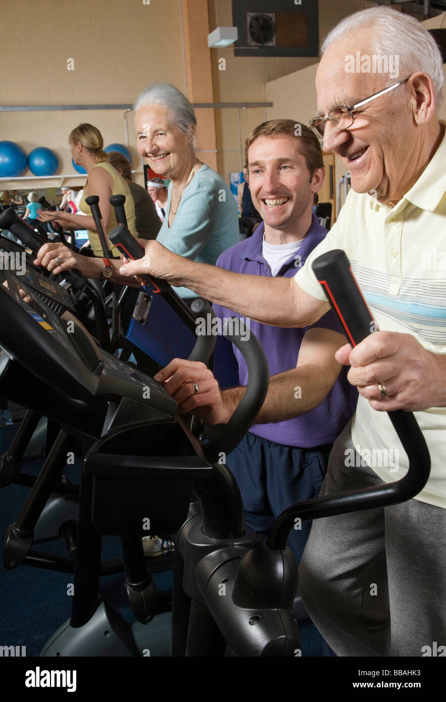 seniors training at gym with instructor Stock Photo - Alamy