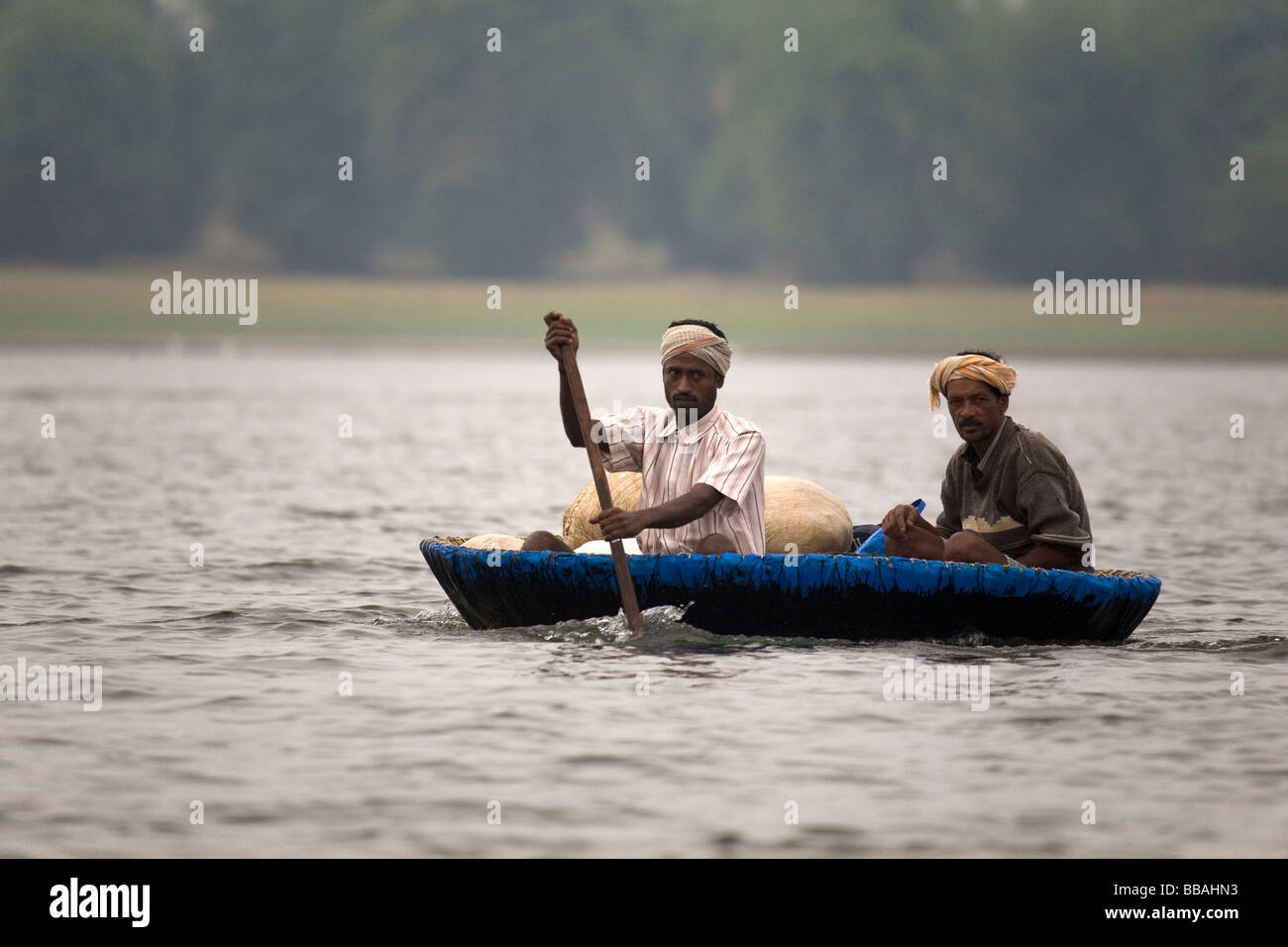Fishermen in southern India paddle a traditional round coracle boat ...
