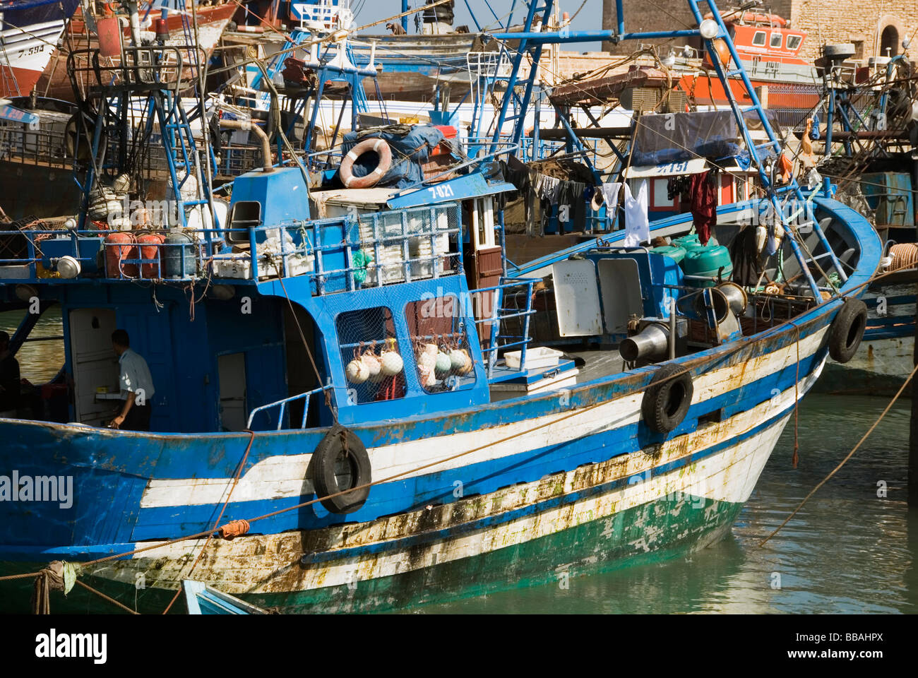 Traditional fishing boats moored in harbour, the white city of ...