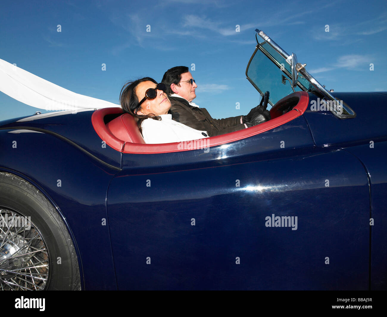 Couple in an old convertible Stock Photo - Alamy