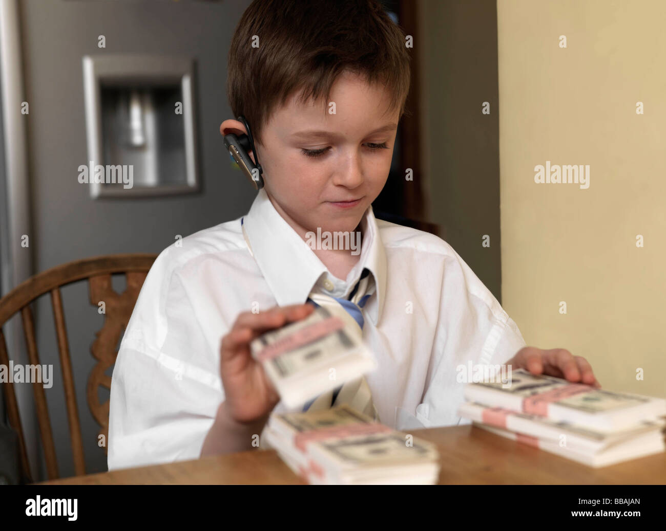 Boy counting money at table Stock Photo - Alamy