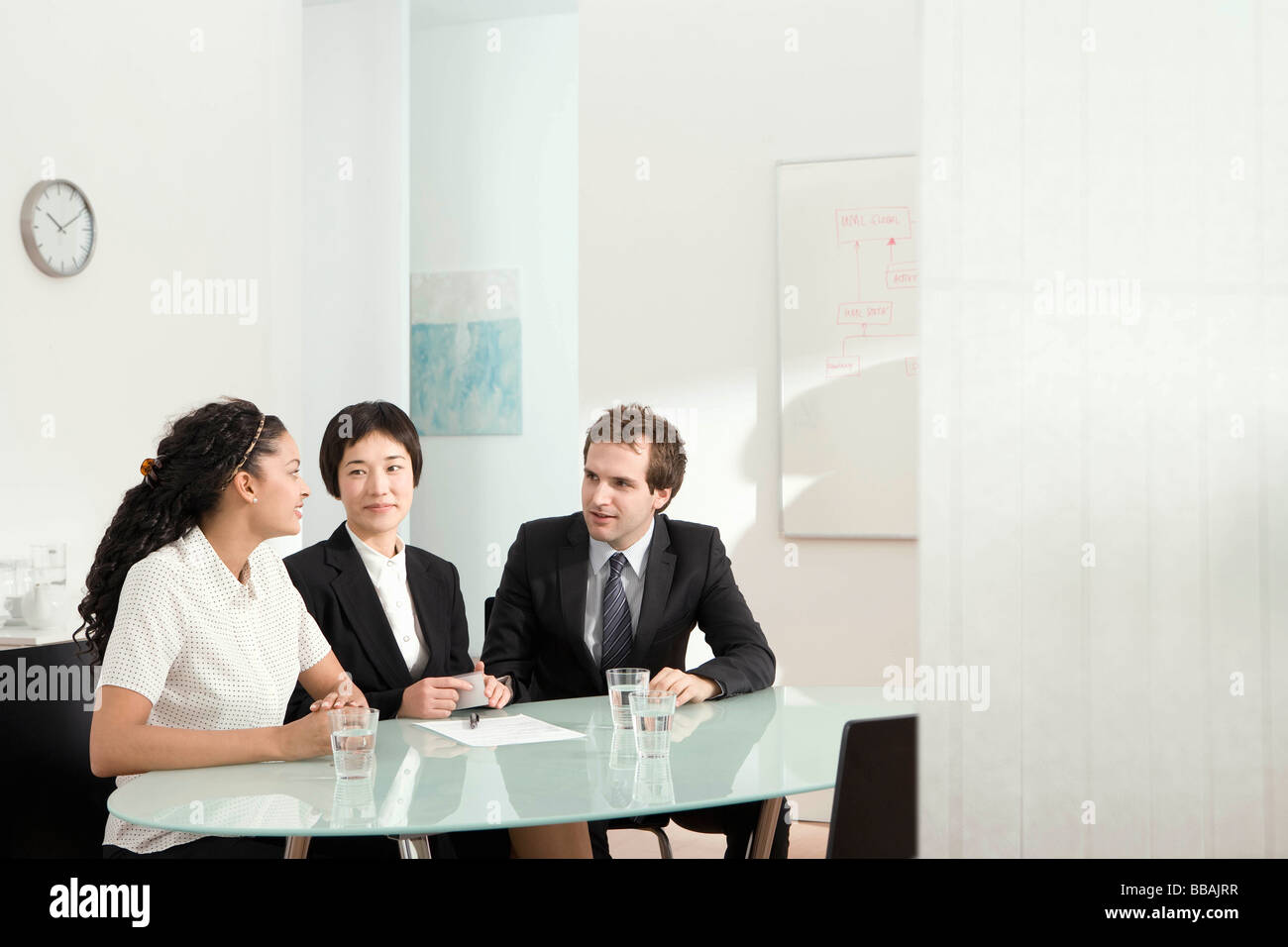 Three colleagues talking Stock Photo - Alamy