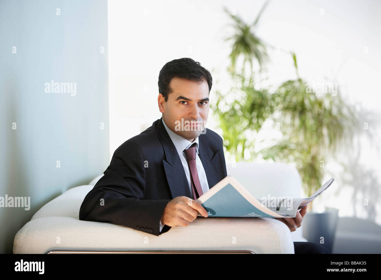 A businessman reading the paper Stock Photo - Alamy