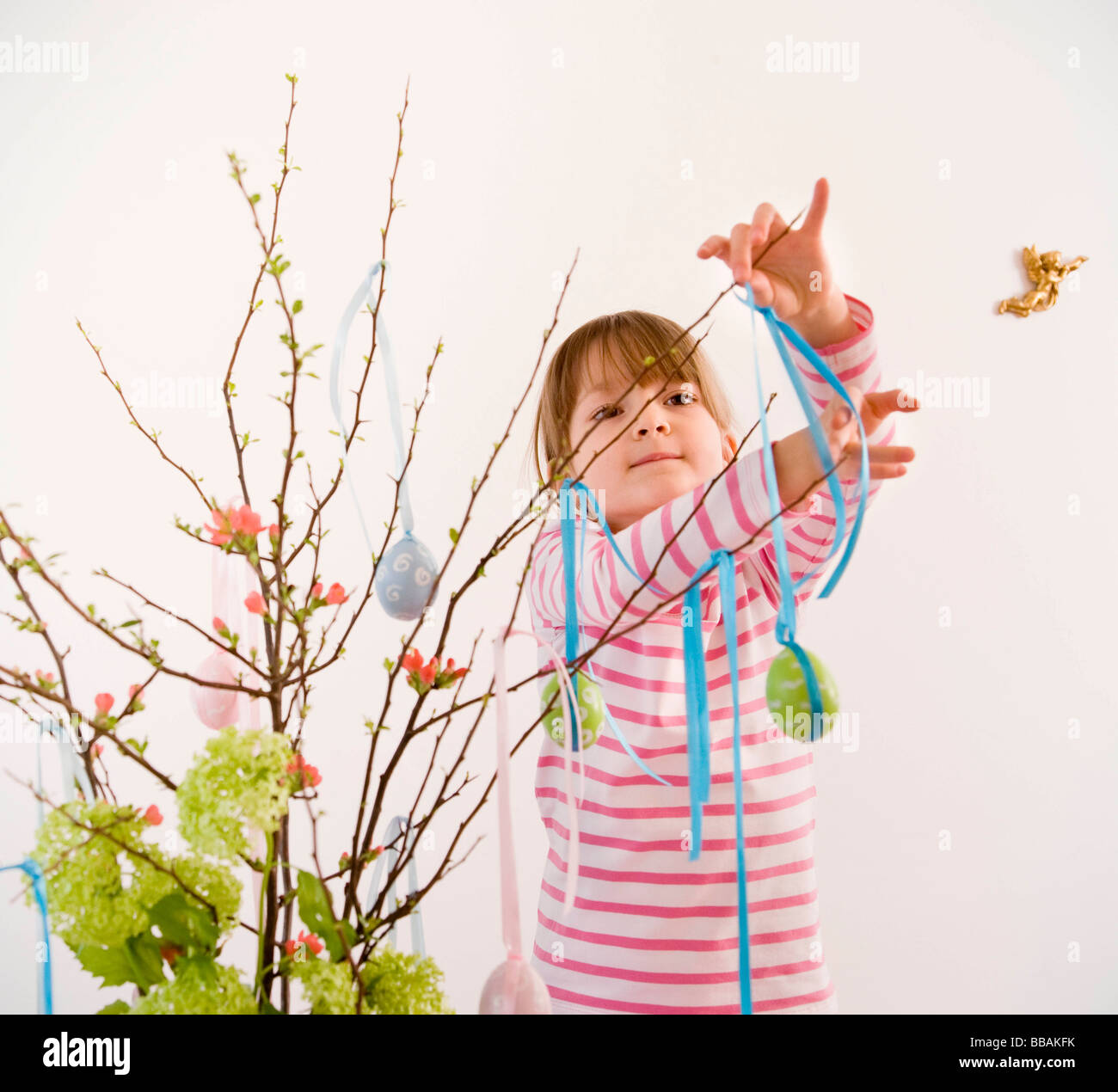 girl decorating twigs for easter Stock Photo - Alamy