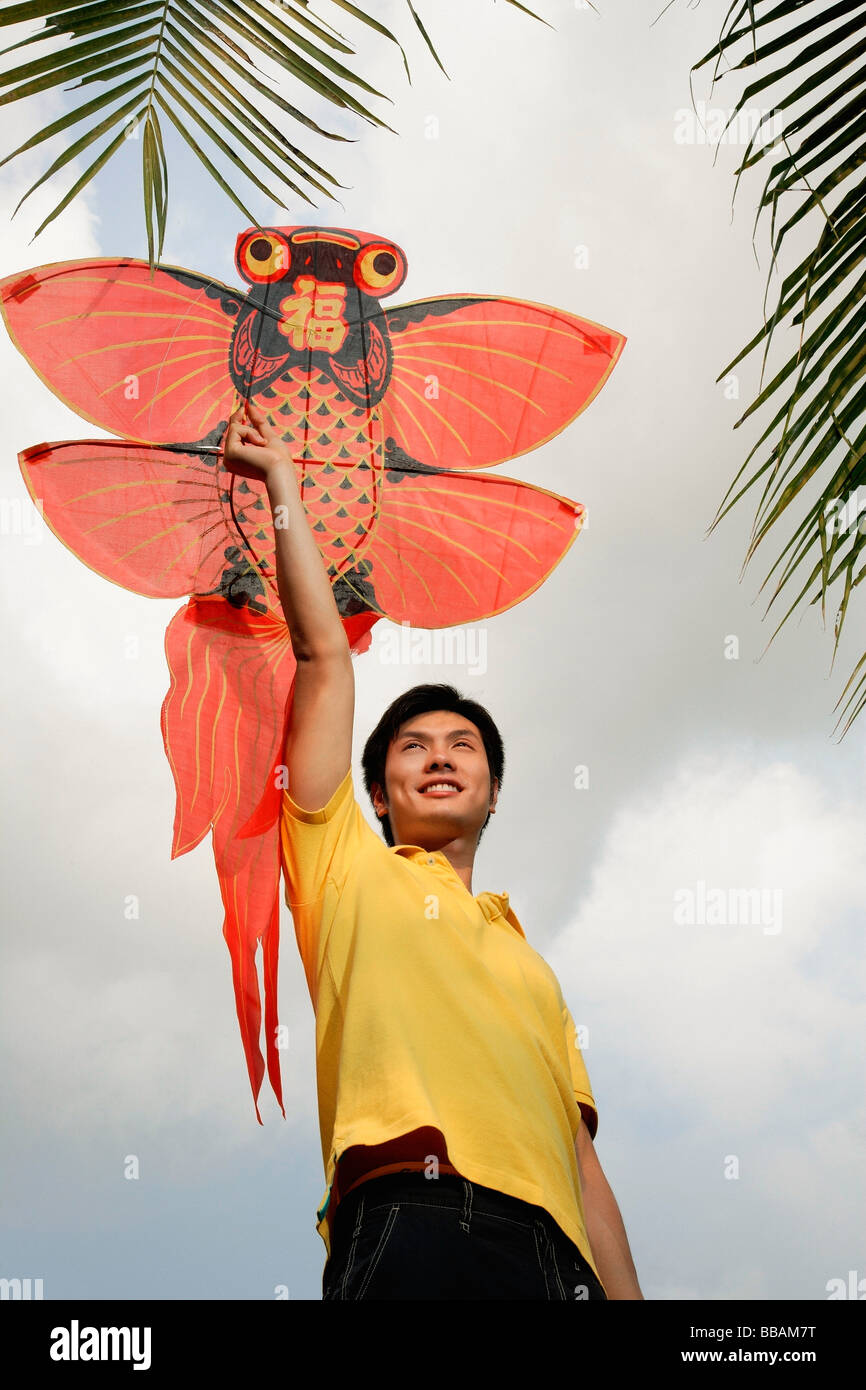 Man flying kite Stock Photo - Alamy
