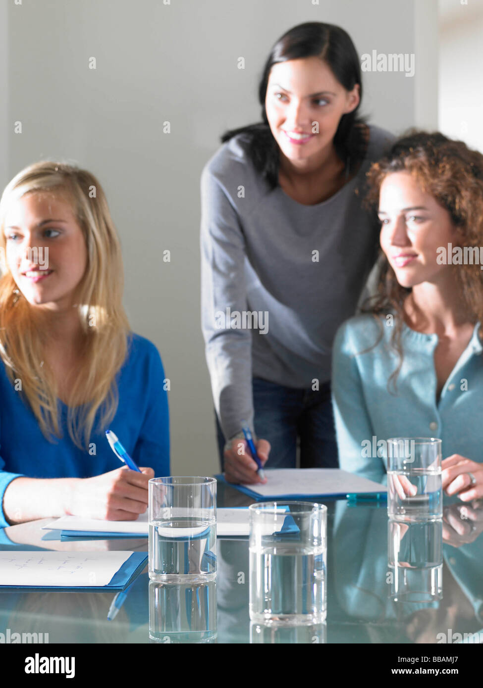 Women working, smiling Stock Photo - Alamy