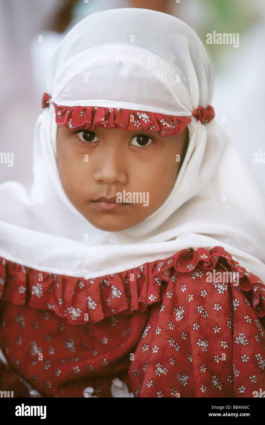 Indonesia, Aceh, Muslim girl in traditional prayer robes (close up ...
