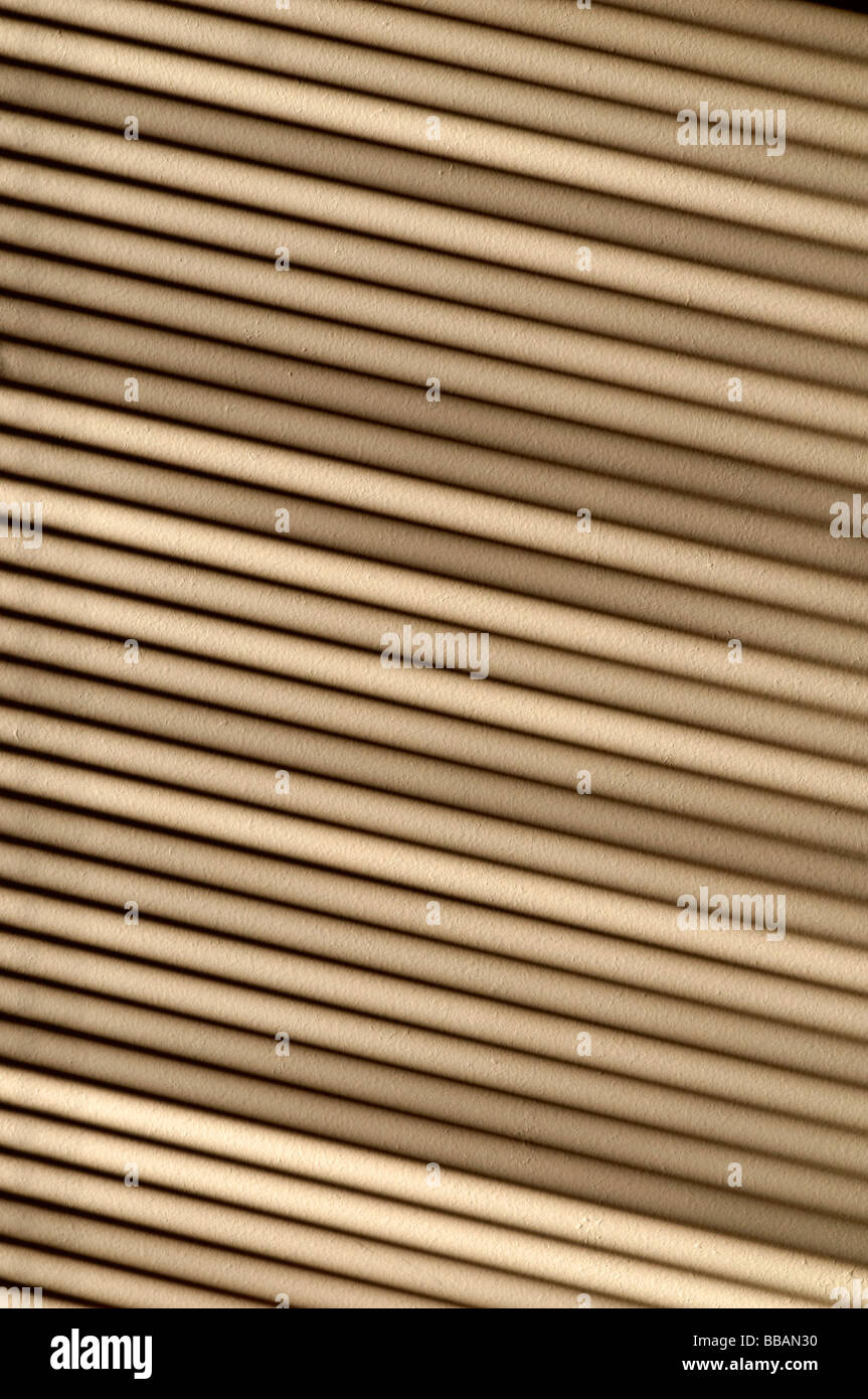 shadow cast from a window and strong sunlight falling on a wall through ...