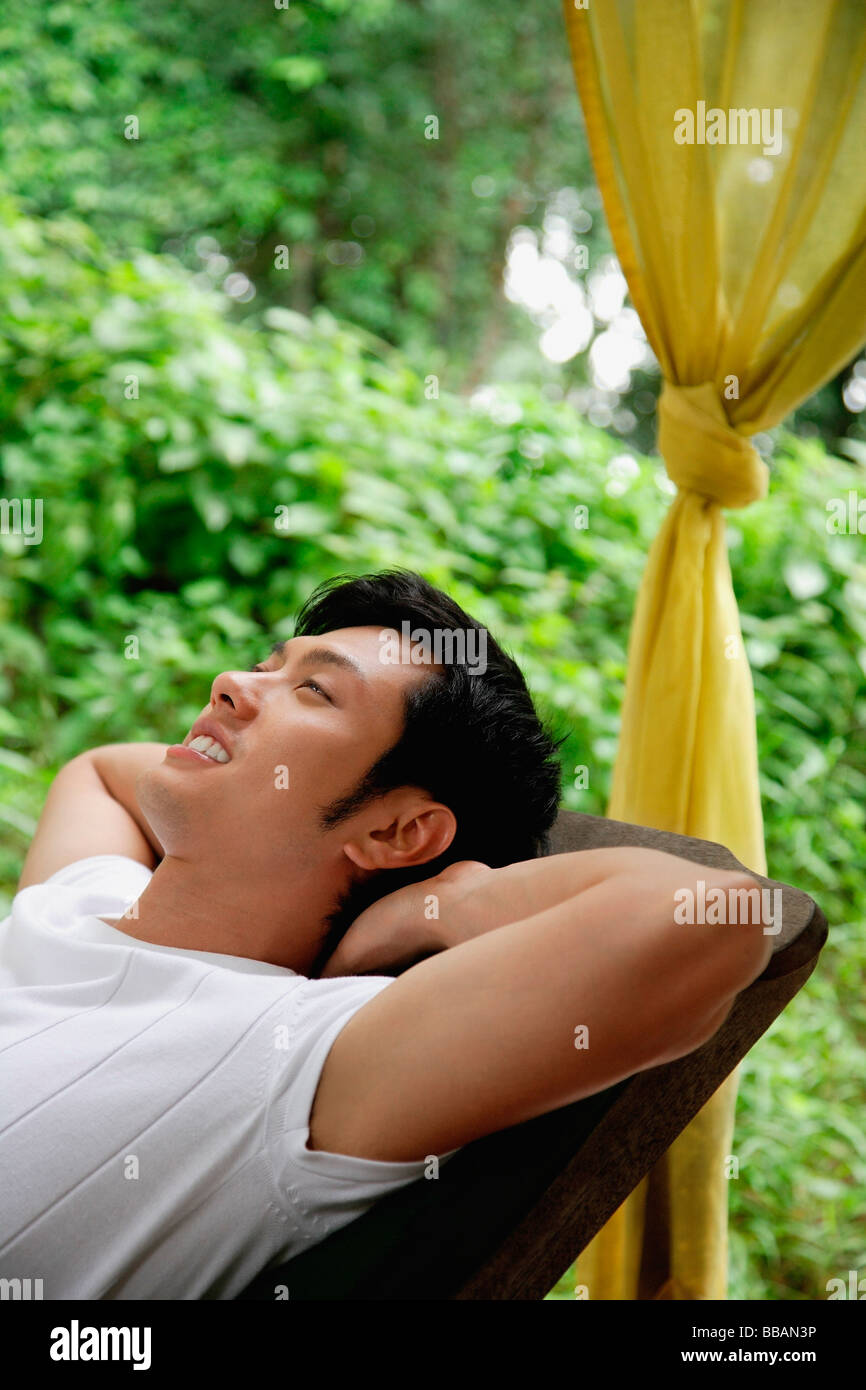 Man laying on lounge chair hi-res stock photography and images - Alamy