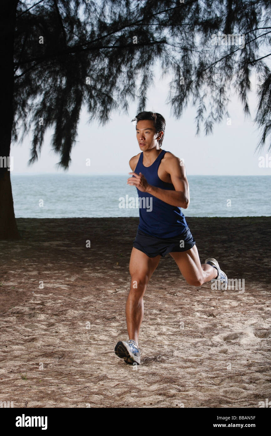 Young asian man jogging along hi-res stock photography and images - Alamy