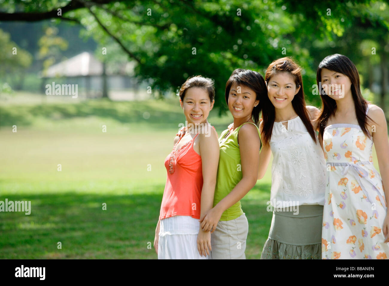 Young women standing side by side, smiling at camera Stock Photo - Alamy
