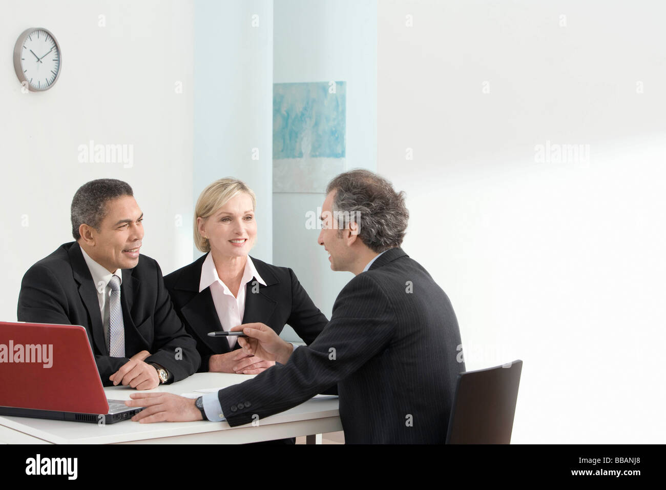 A business discussion with laptop Stock Photo - Alamy