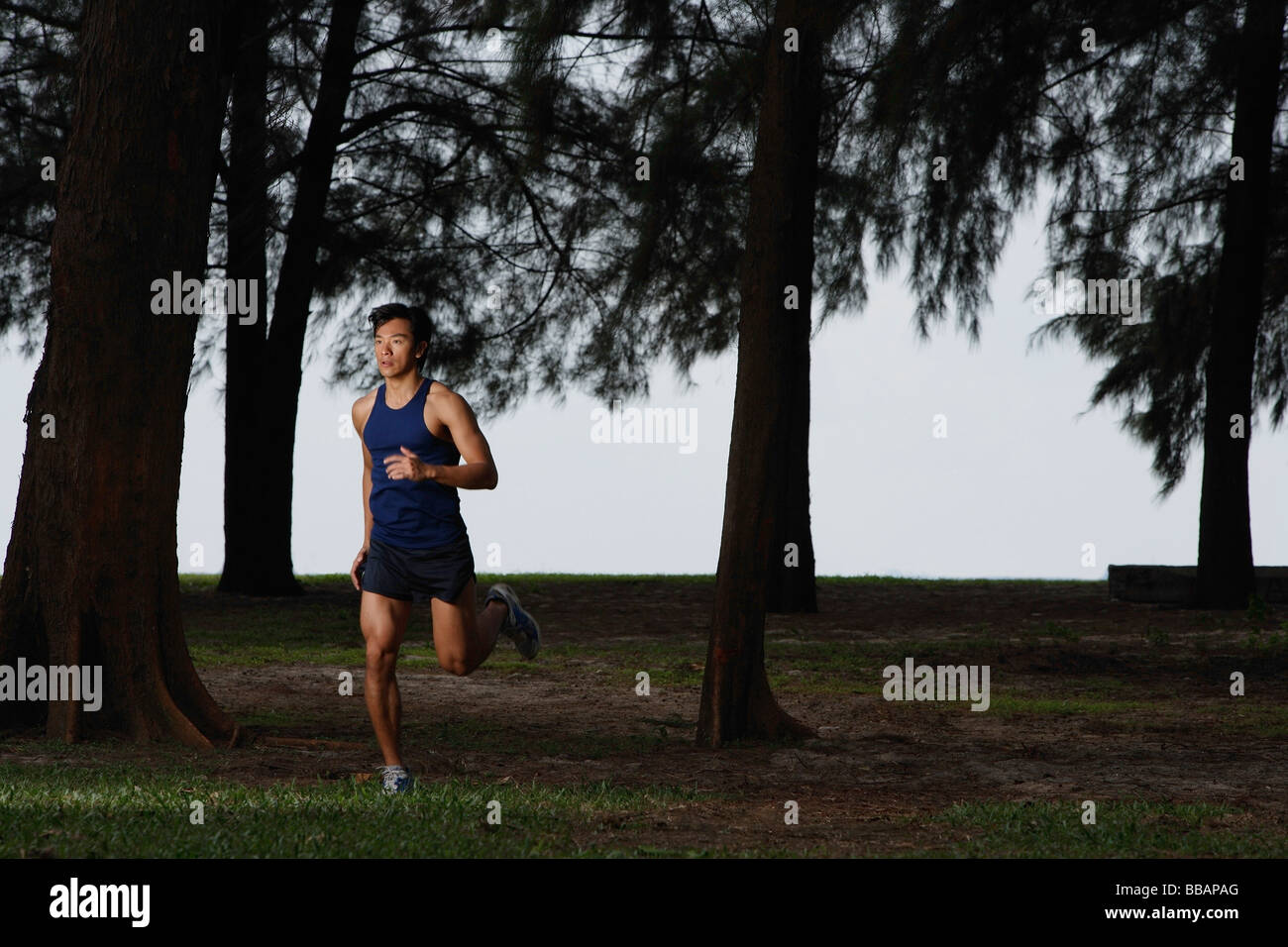 Man running through park Stock Photo - Alamy