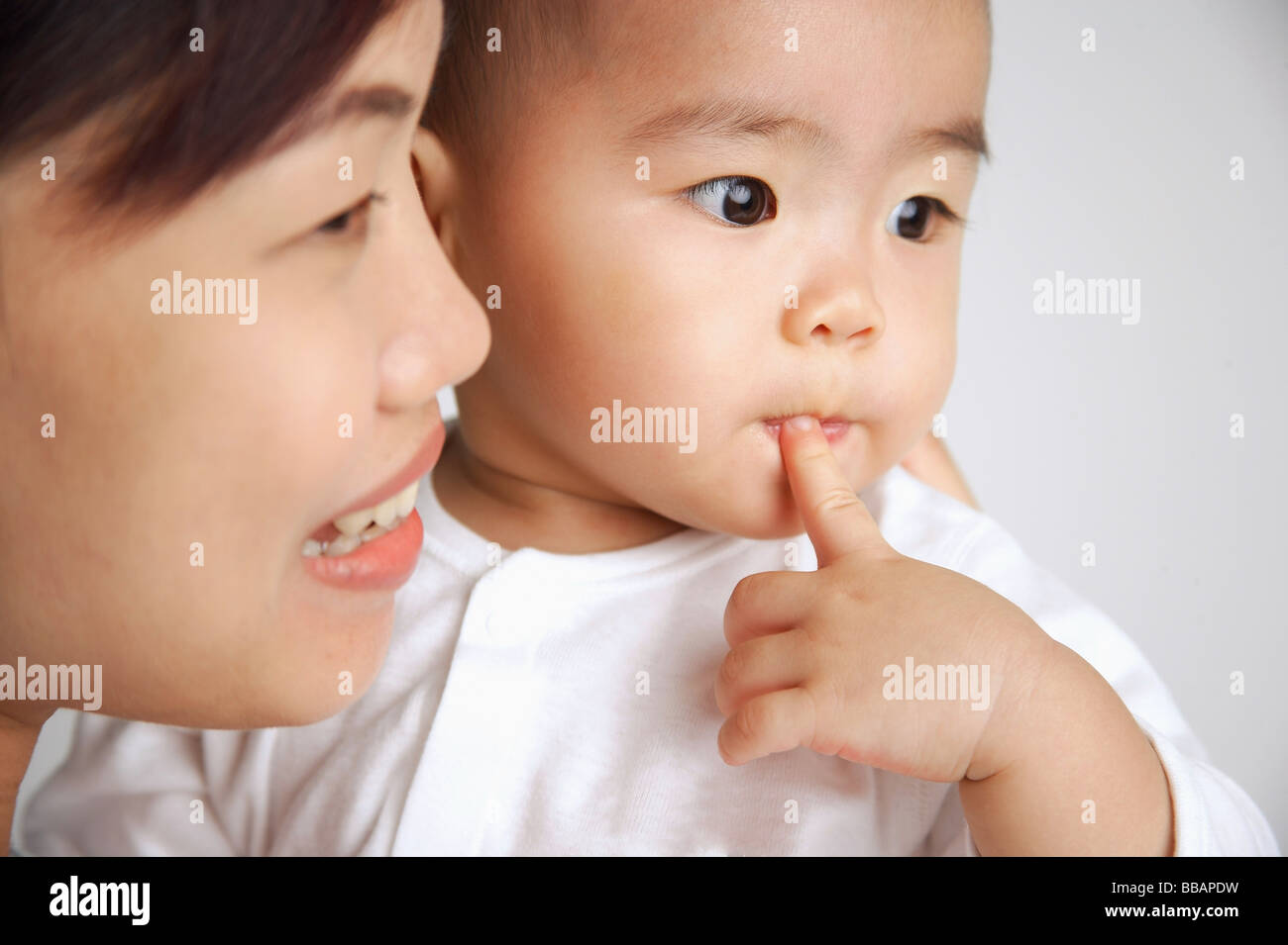 Mother with baby, head shot, looking away Stock Photo - Alamy
