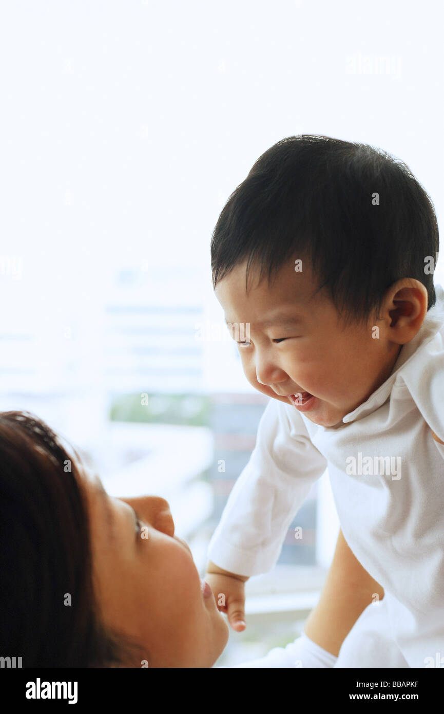 Mother carrying baby boy, face to face Stock Photo - Alamy