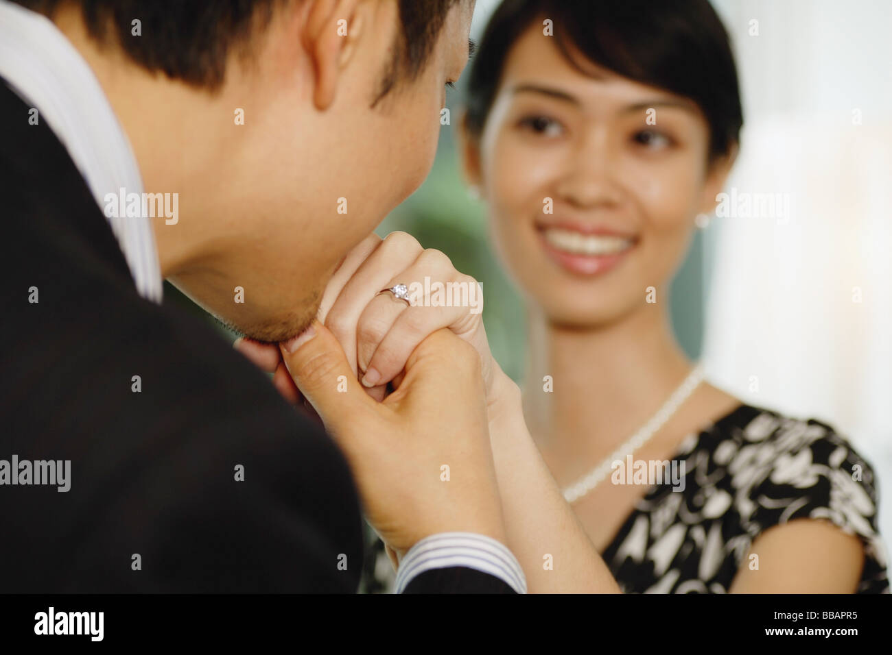 Man kissing hand of woman Stock Photo - Alamy