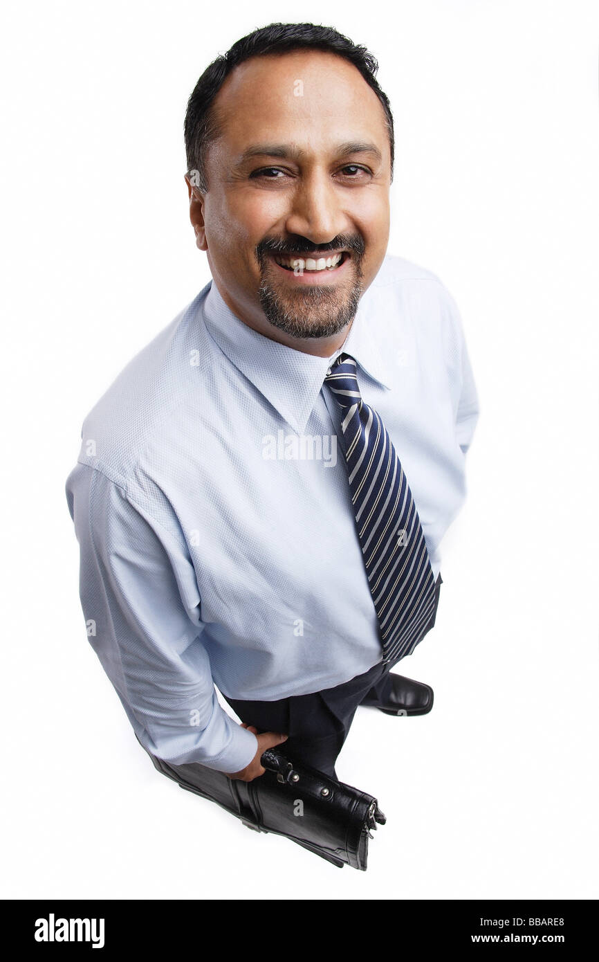 Businessman standing, smiling at camera Stock Photo - Alamy