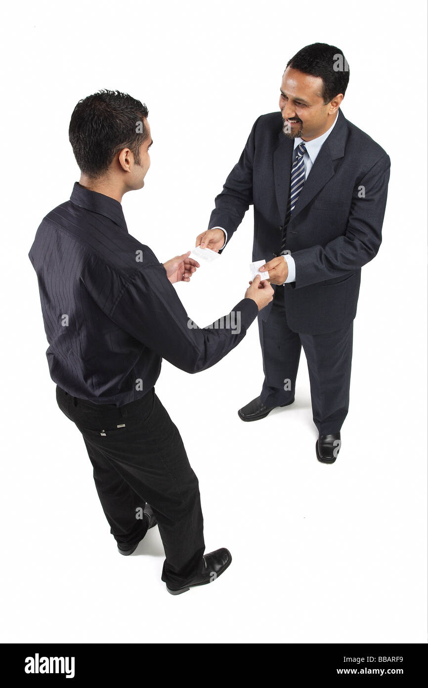 Two businessmen standing and exchanging namecards Stock Photo - Alamy
