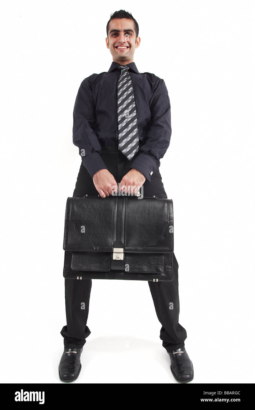 Executive carrying briefcase looking at camera Stock Photo - Alamy
