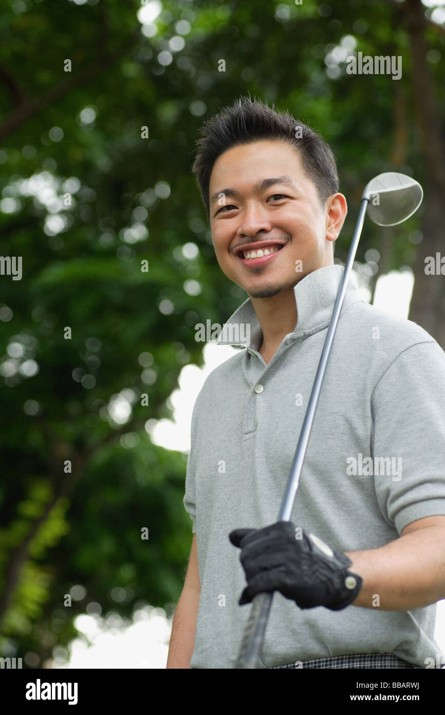Man with golf club on shoulder, smiling at camera Stock Photo - Alamy
