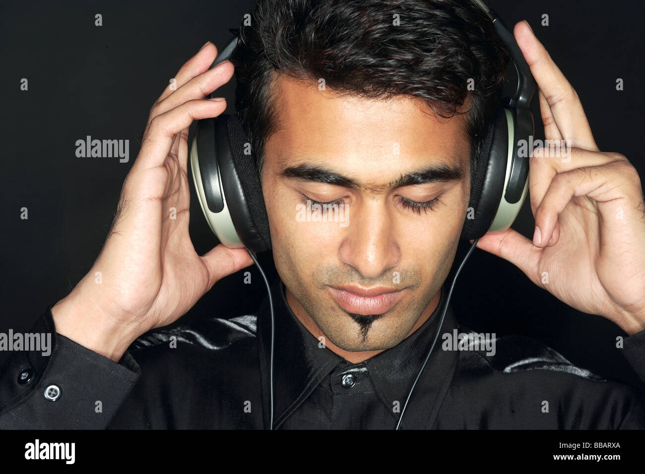 Man listening to music with headphones Stock Photo - Alamy