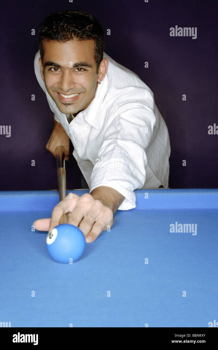 Young man playing pool, smiling at camera, portrait Stock Photo - Alamy