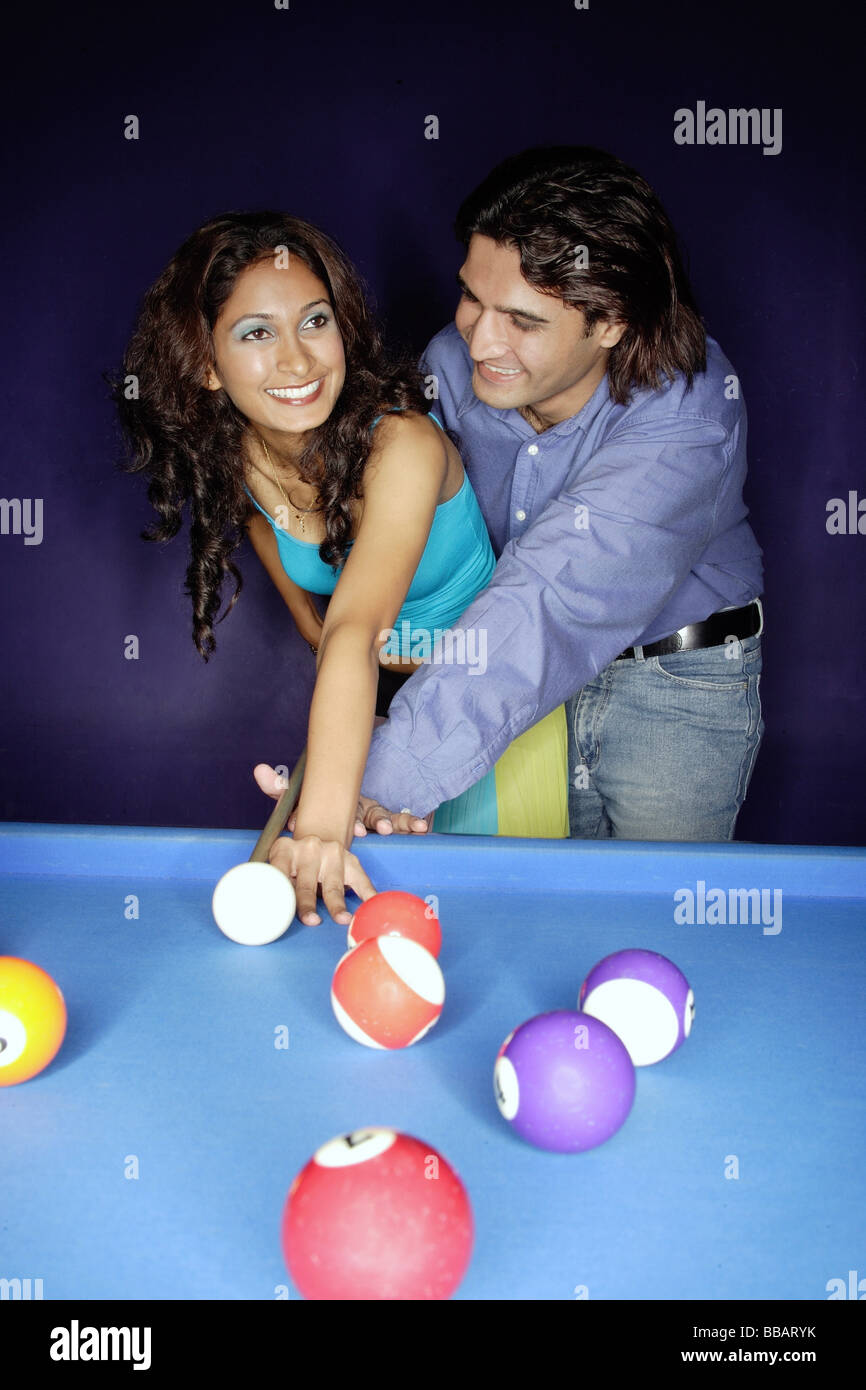 Man teaching woman how to play pool Stock Photo - Alamy