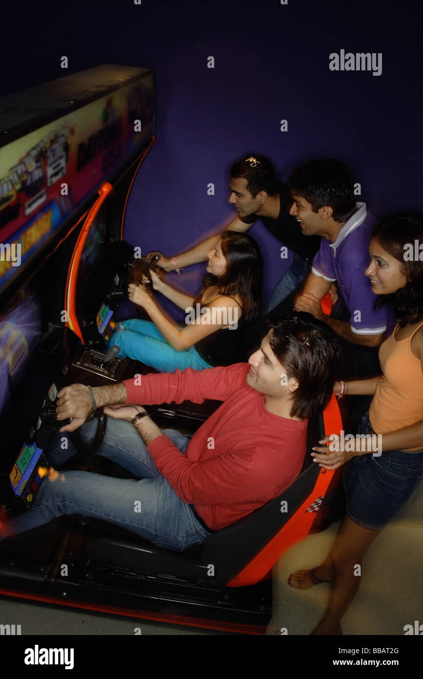 Young adults in amusement arcade Stock Photo - Alamy