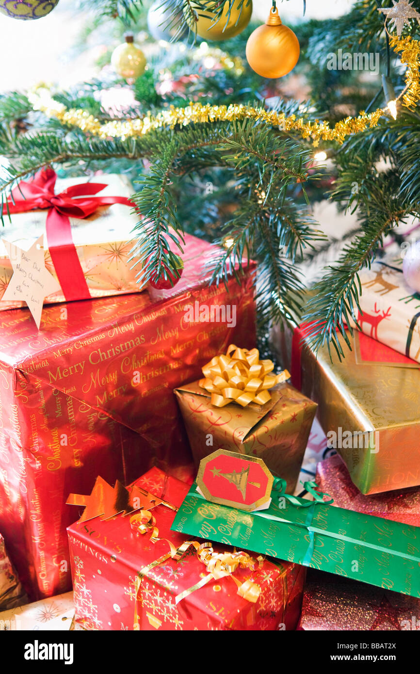 Christmas presents under decorated tree Stock Photo - Alamy