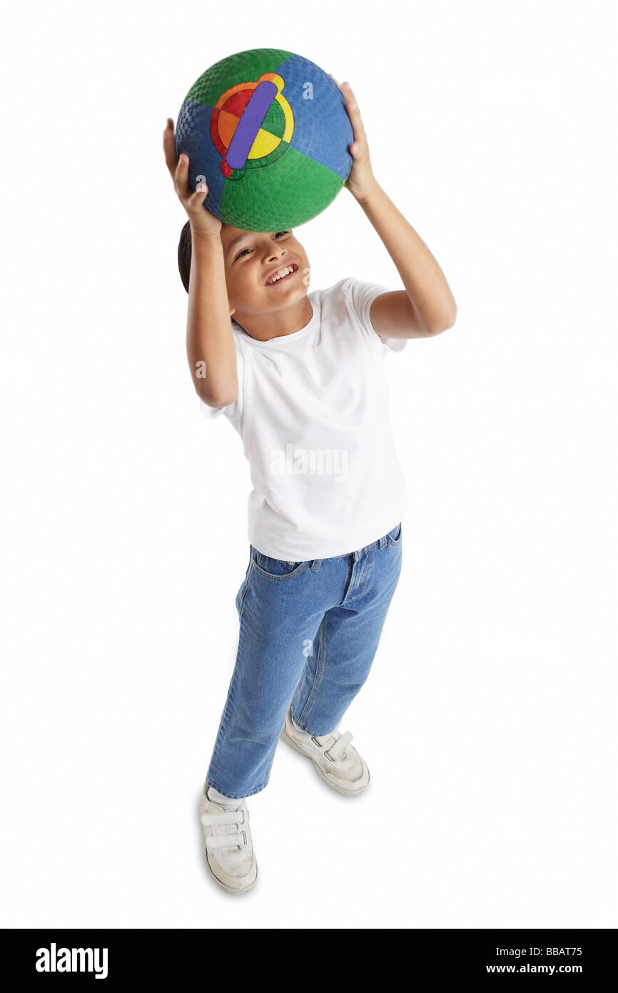 Boy holding basketball, looking up Stock Photo - Alamy