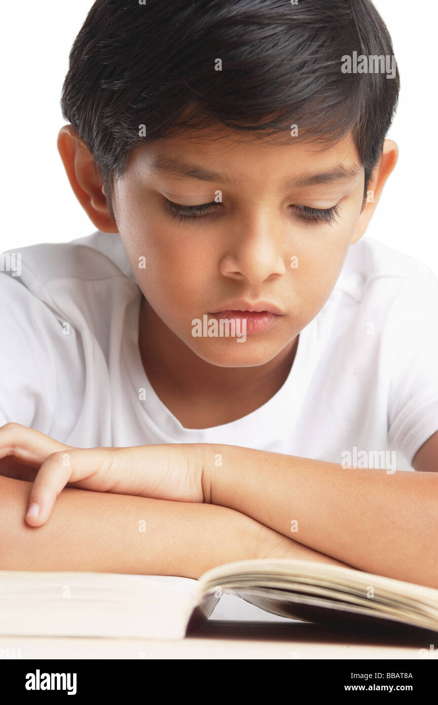Boy reading book Stock Photo - Alamy