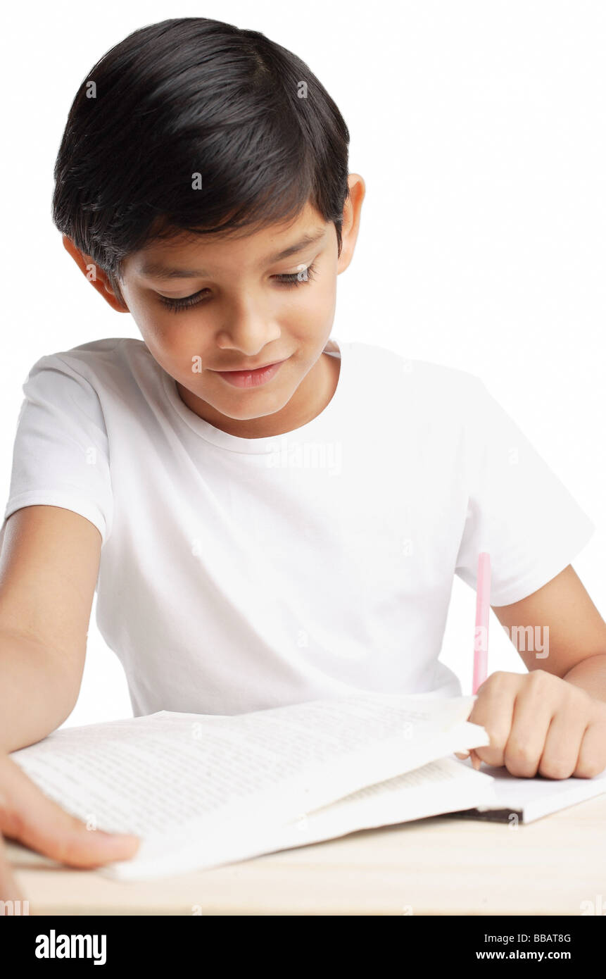 Boy with book and pencil, writing Stock Photo - Alamy