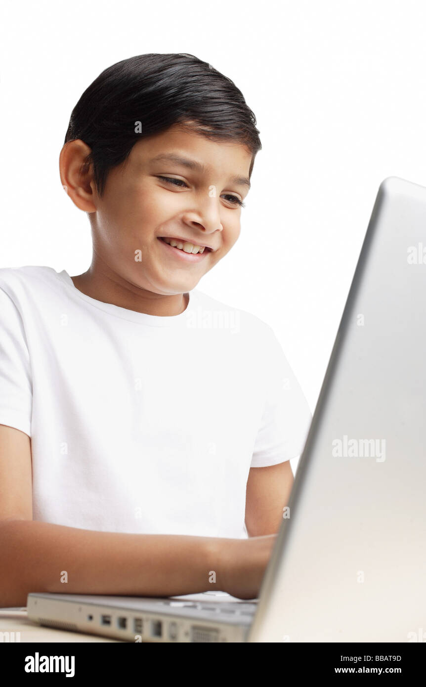 Boy using laptop, smiling Stock Photo - Alamy