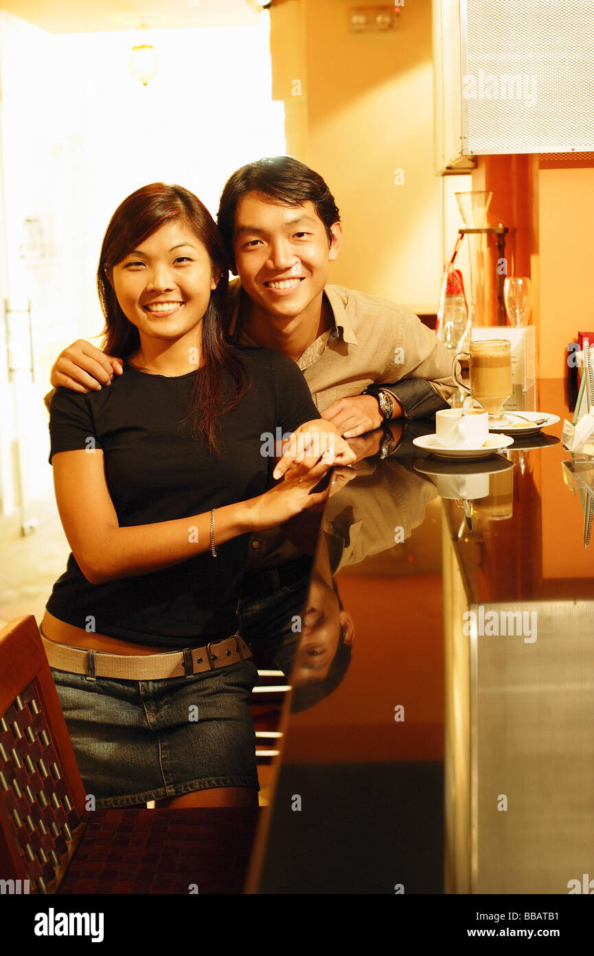 Couple standing at bar counter, looking at camera, portrait Stock Photo ...