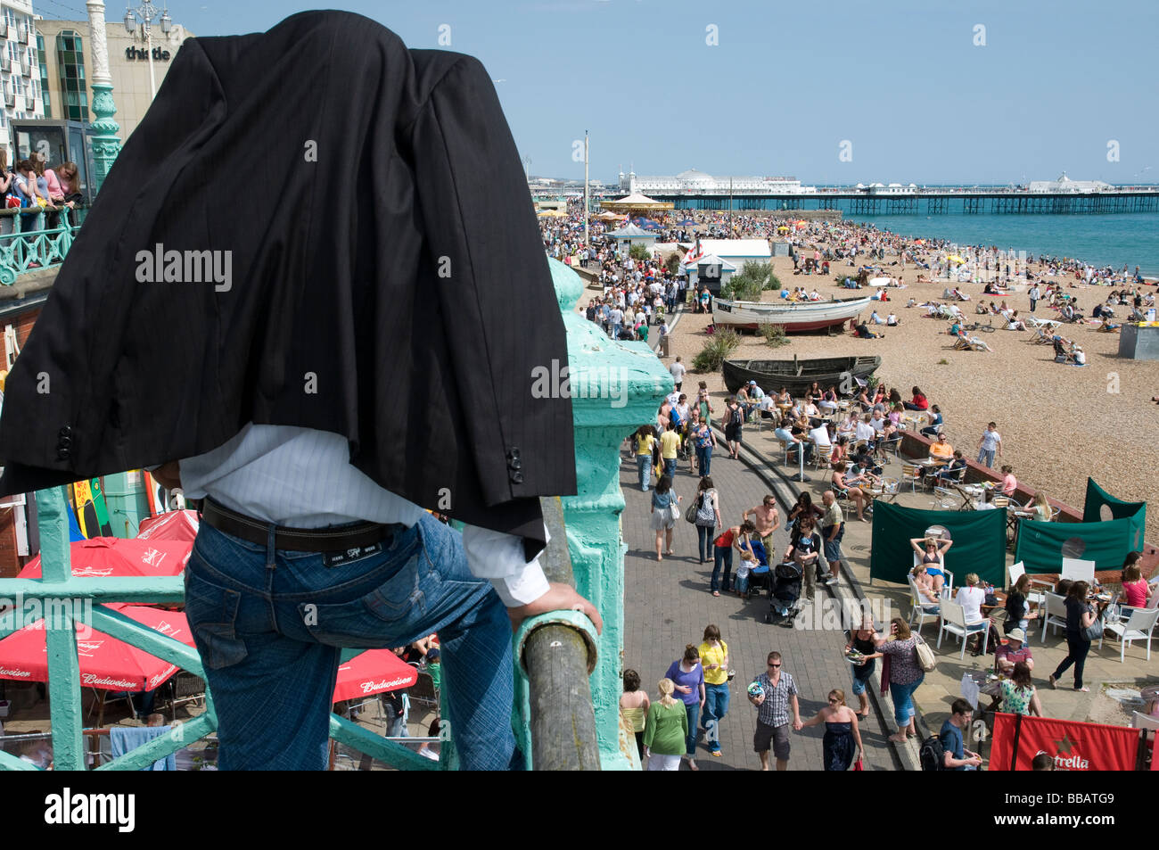 A man seeking shade beneath his jacket Stock Photo - Alamy