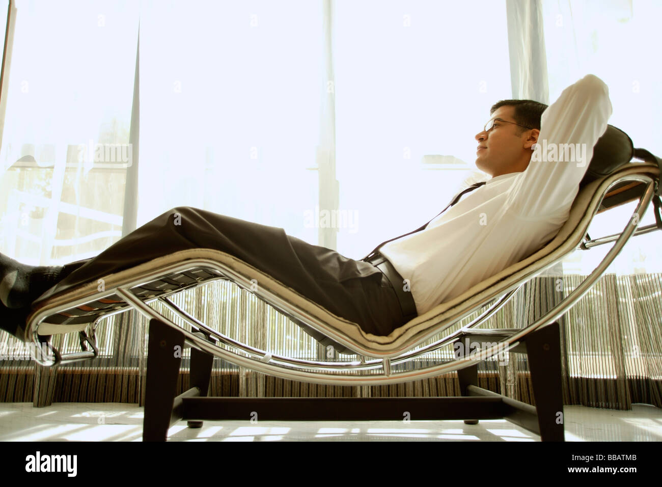 Businessman reclining on chair hi-res stock photography and images - Alamy