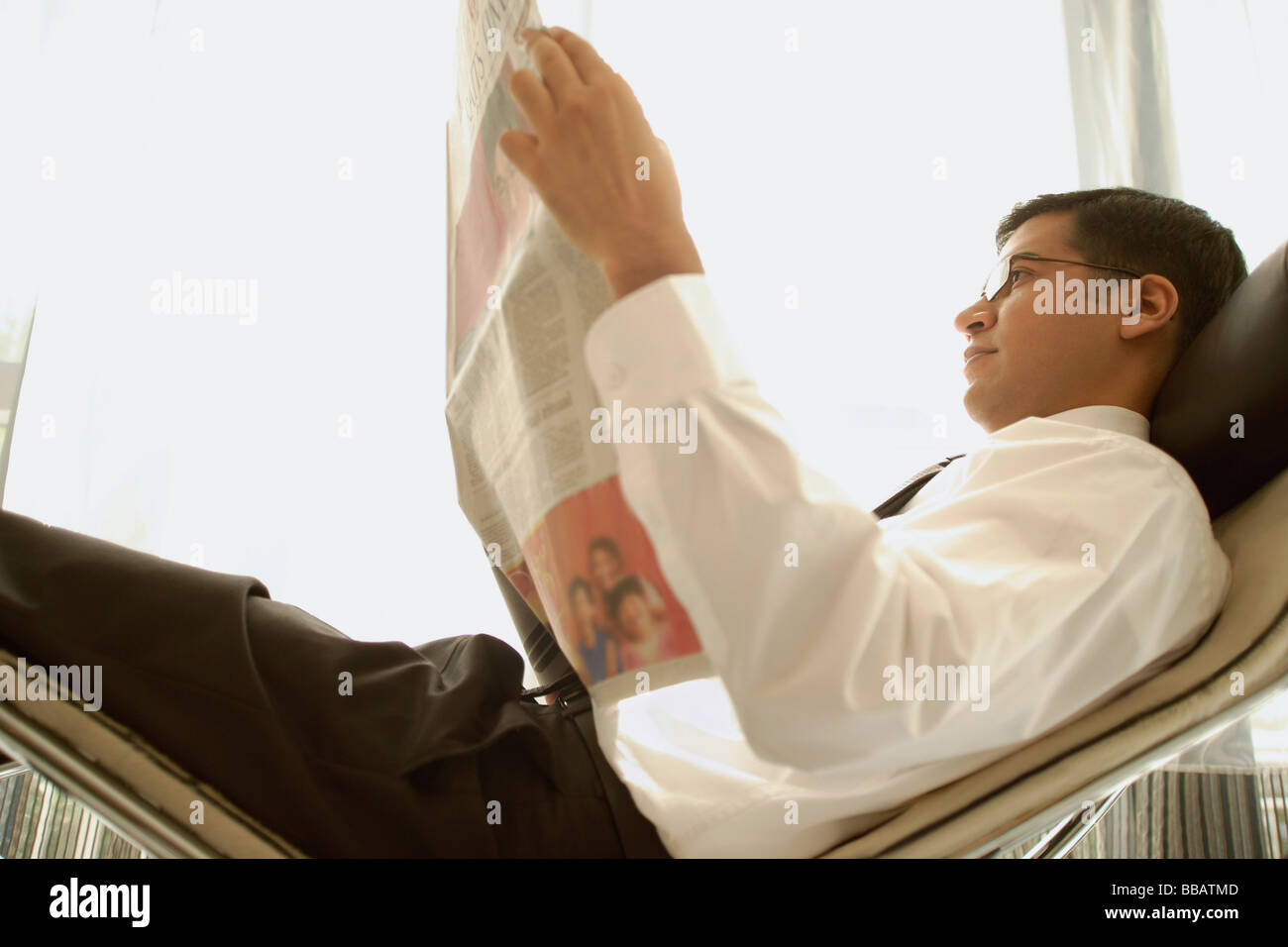 Asian indian businessman reading newspaper hi-res stock photography and ...