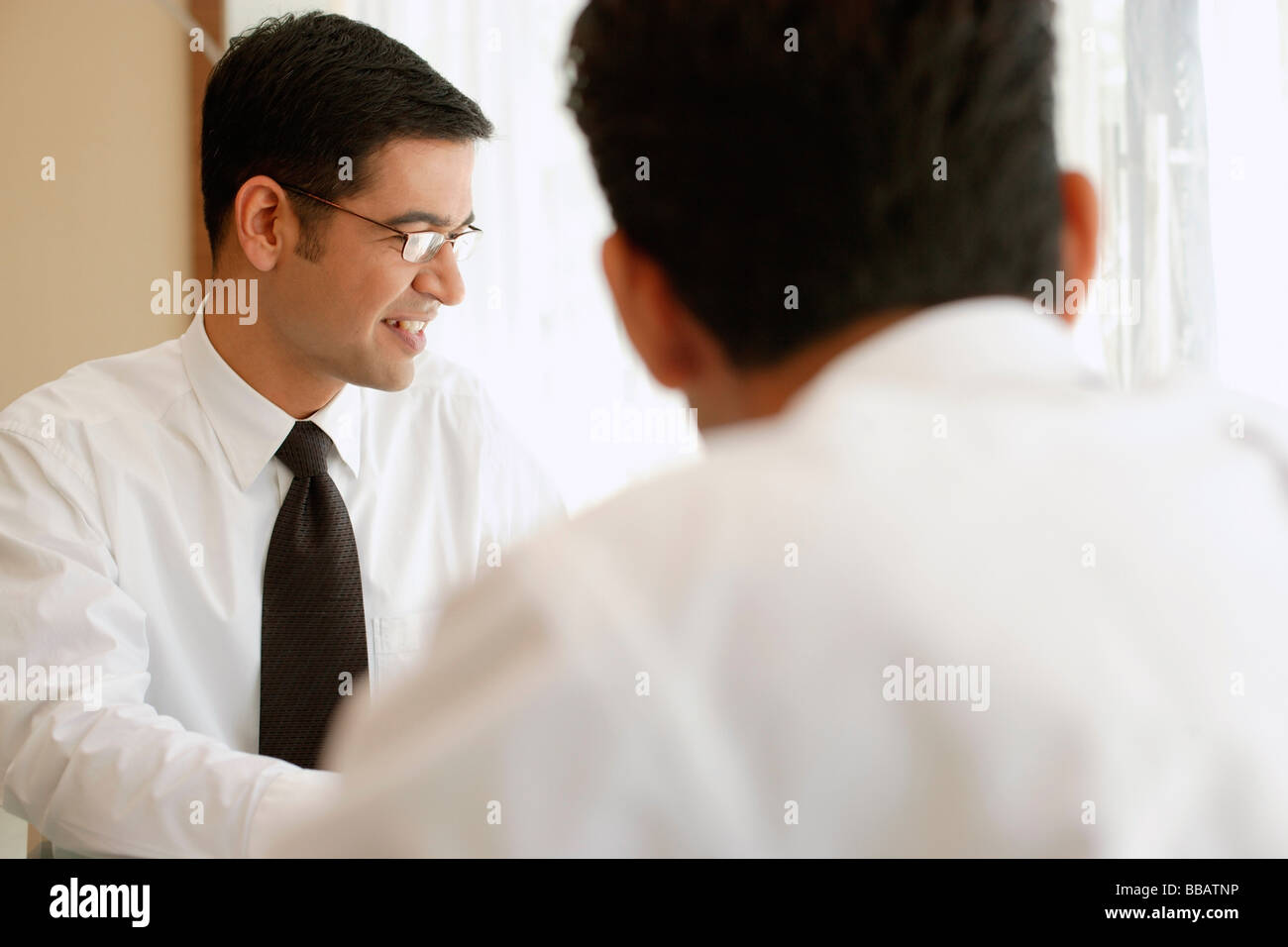 Indian man looking over eyeglasses hi-res stock photography and images ...