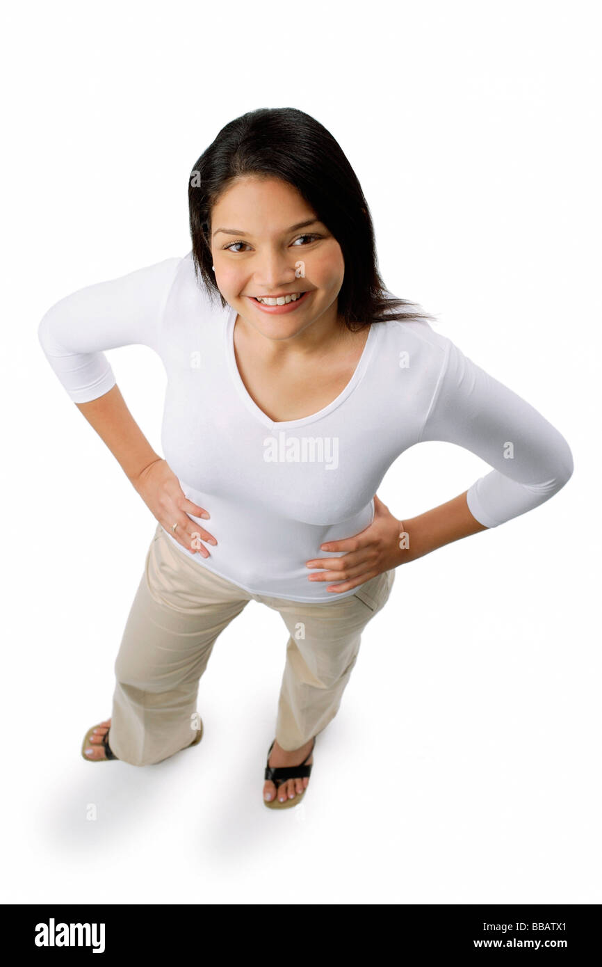 Woman with hands on hips, smiling at camera Stock Photo - Alamy