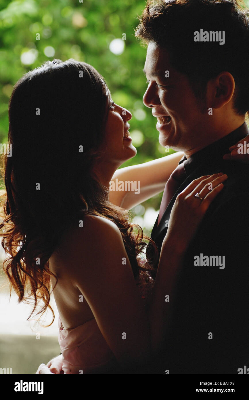 Couple embracing, standing face to face, smiling at each other Stock ...