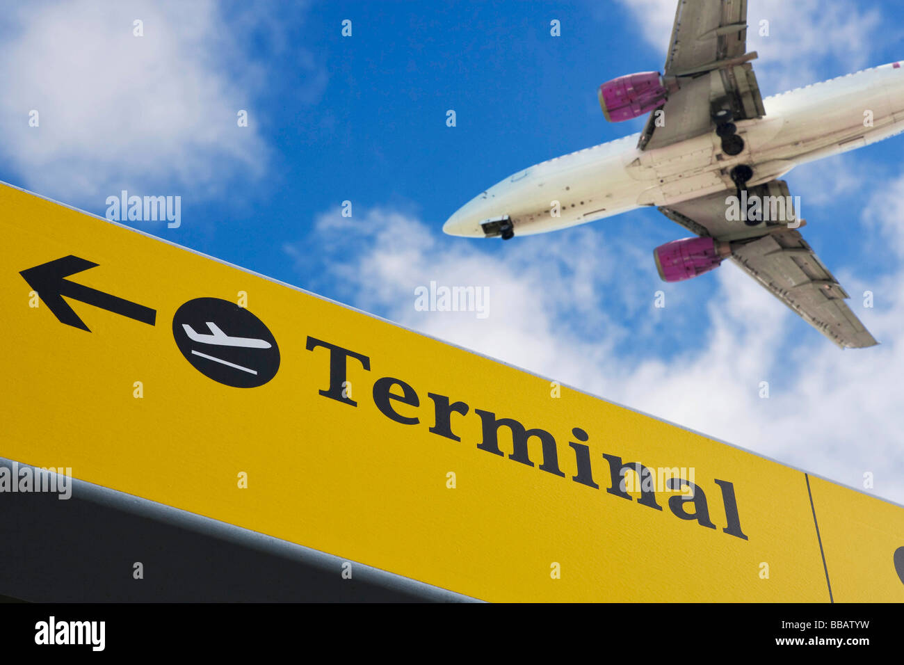 Plane flying over 'terminal' sign Stock Photo - Alamy