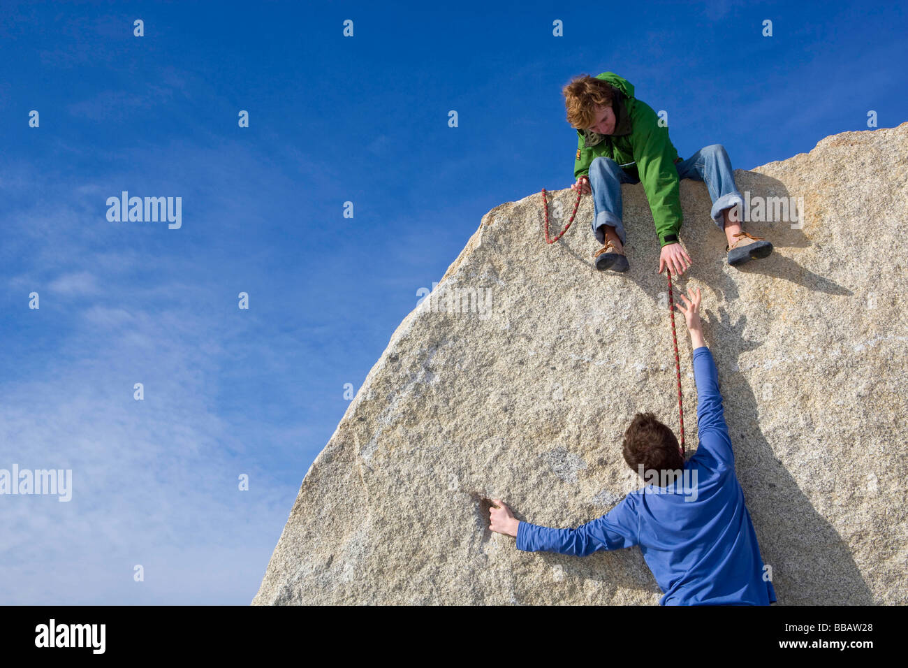 Climber helping fellow climber Stock Photo - Alamy
