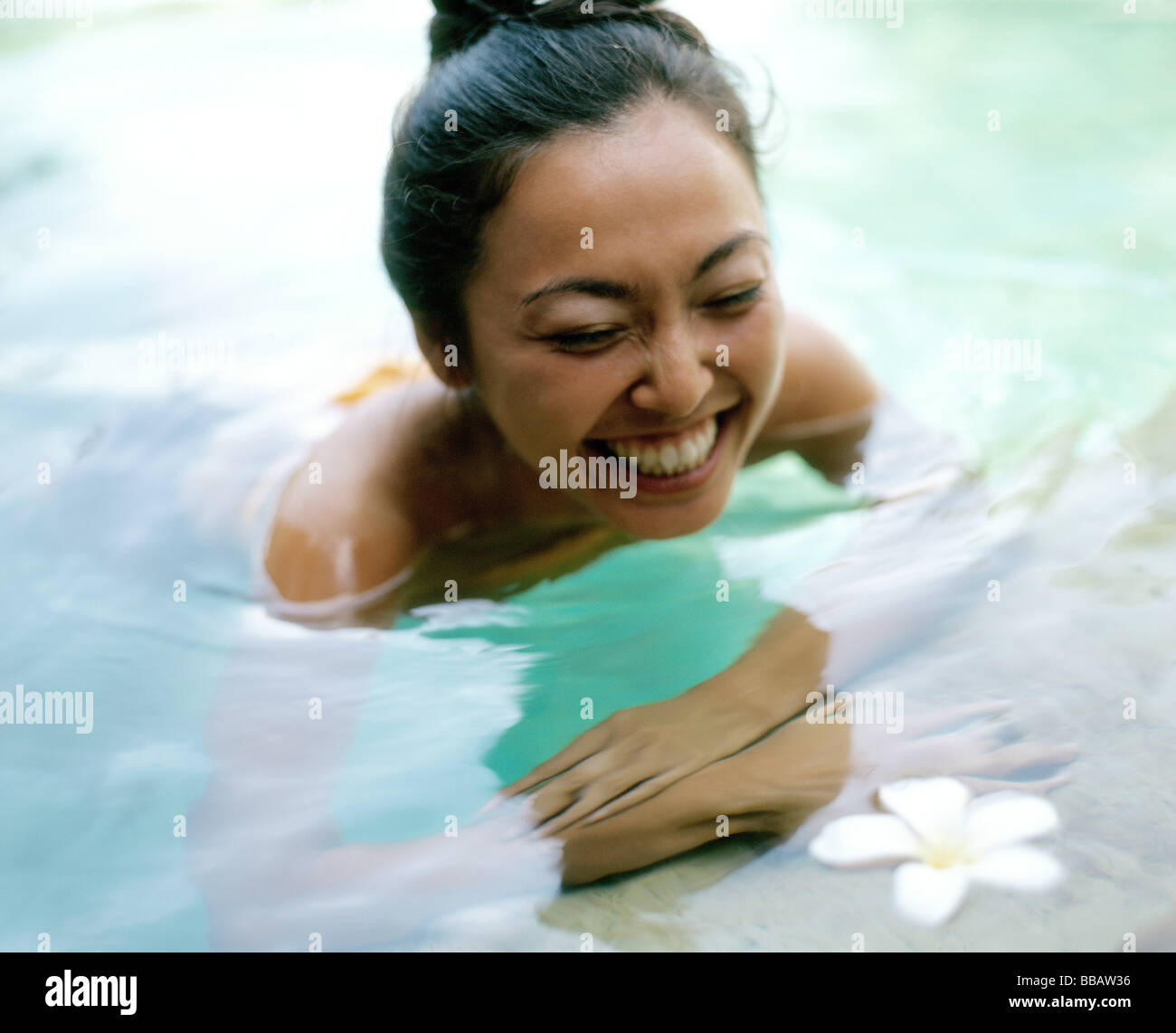 Woman in pool smiling Stock Photo - Alamy