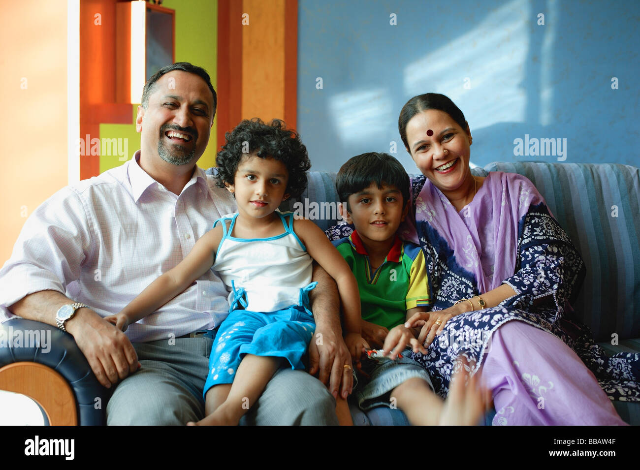 Family with two children, smiling at camera Stock Photo - Alamy