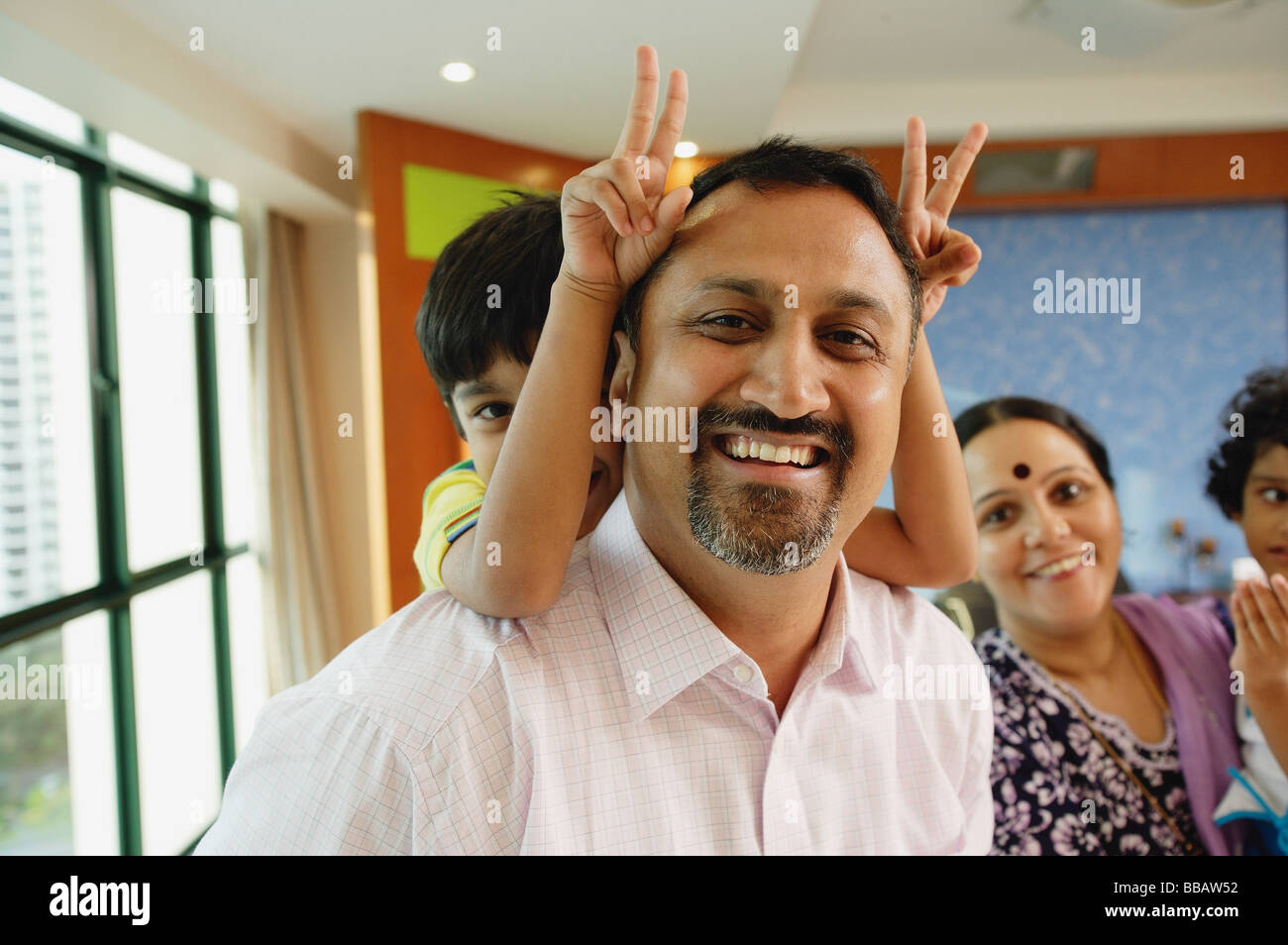 Indian man carrying daughter on hi-res stock photography and images - Alamy