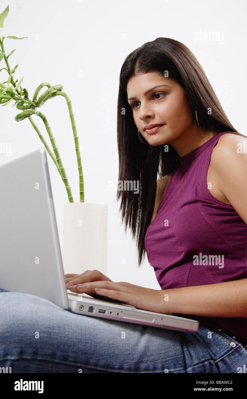 Woman sitting, using laptop Stock Photo - Alamy