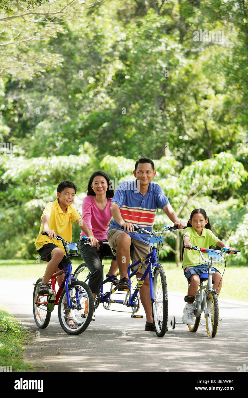 Family in park, riding bicycles Stock Photo - Alamy