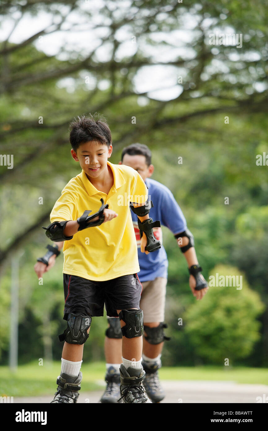 Father and son racing in park Stock Photo - Alamy